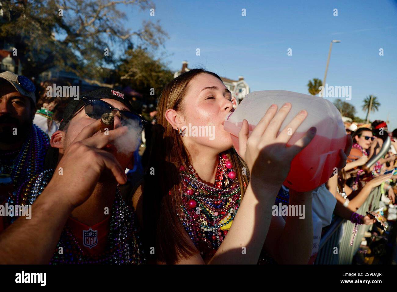 Revelers enjoy drinks and cigars during the Gasparilla Parade of ...