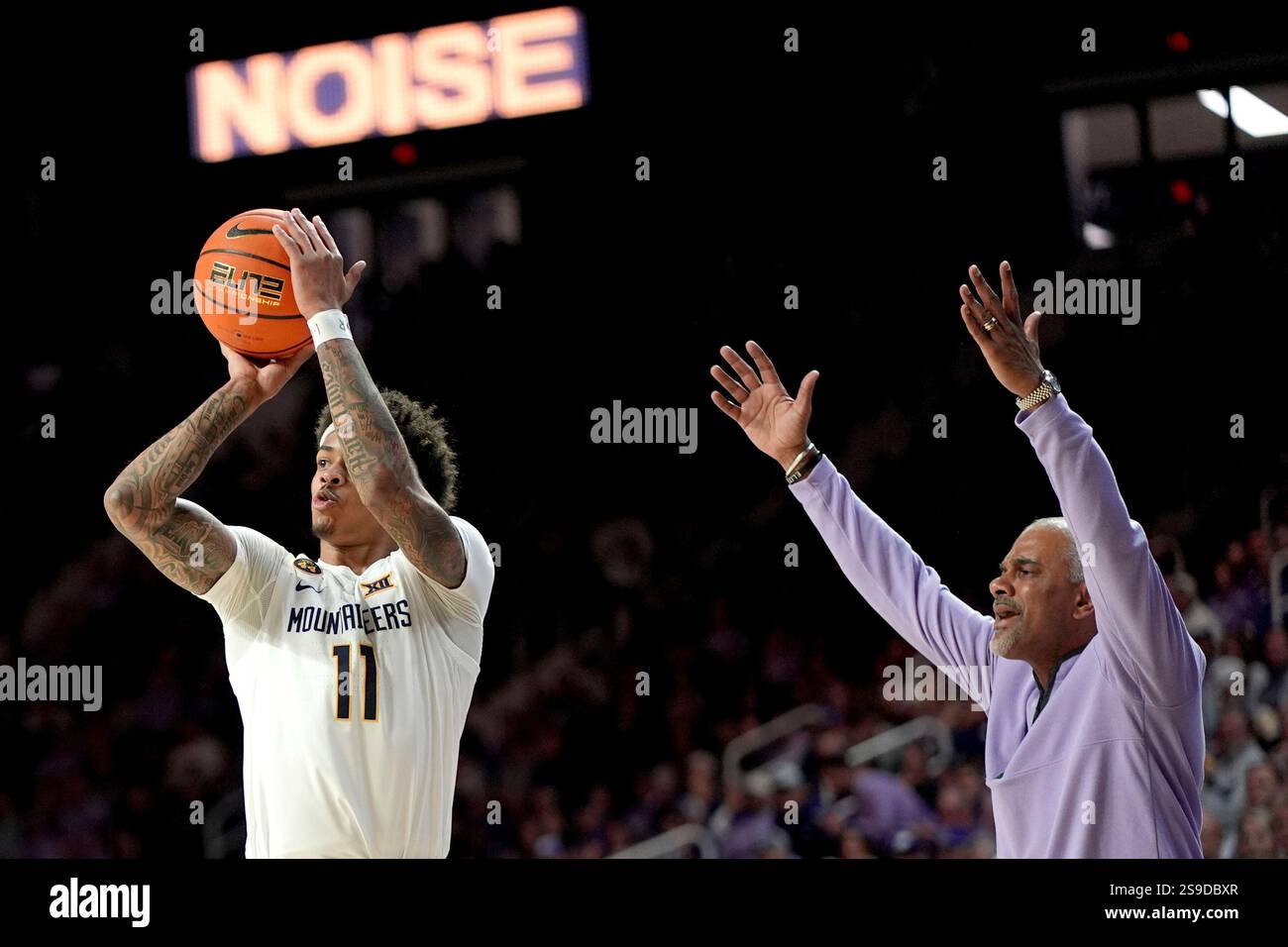 West Virginia guard Jonathan Powell (11) shoots while Kansas State head ...
