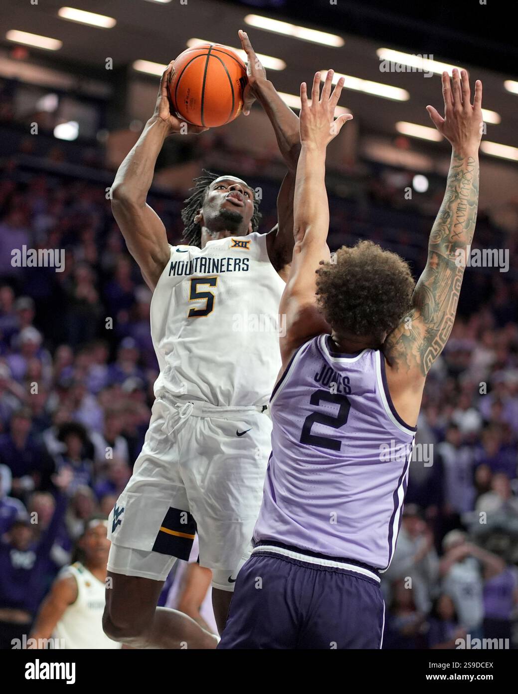 West Virginia guard Toby Okani (5) shoots over Kansas State guard Max ...