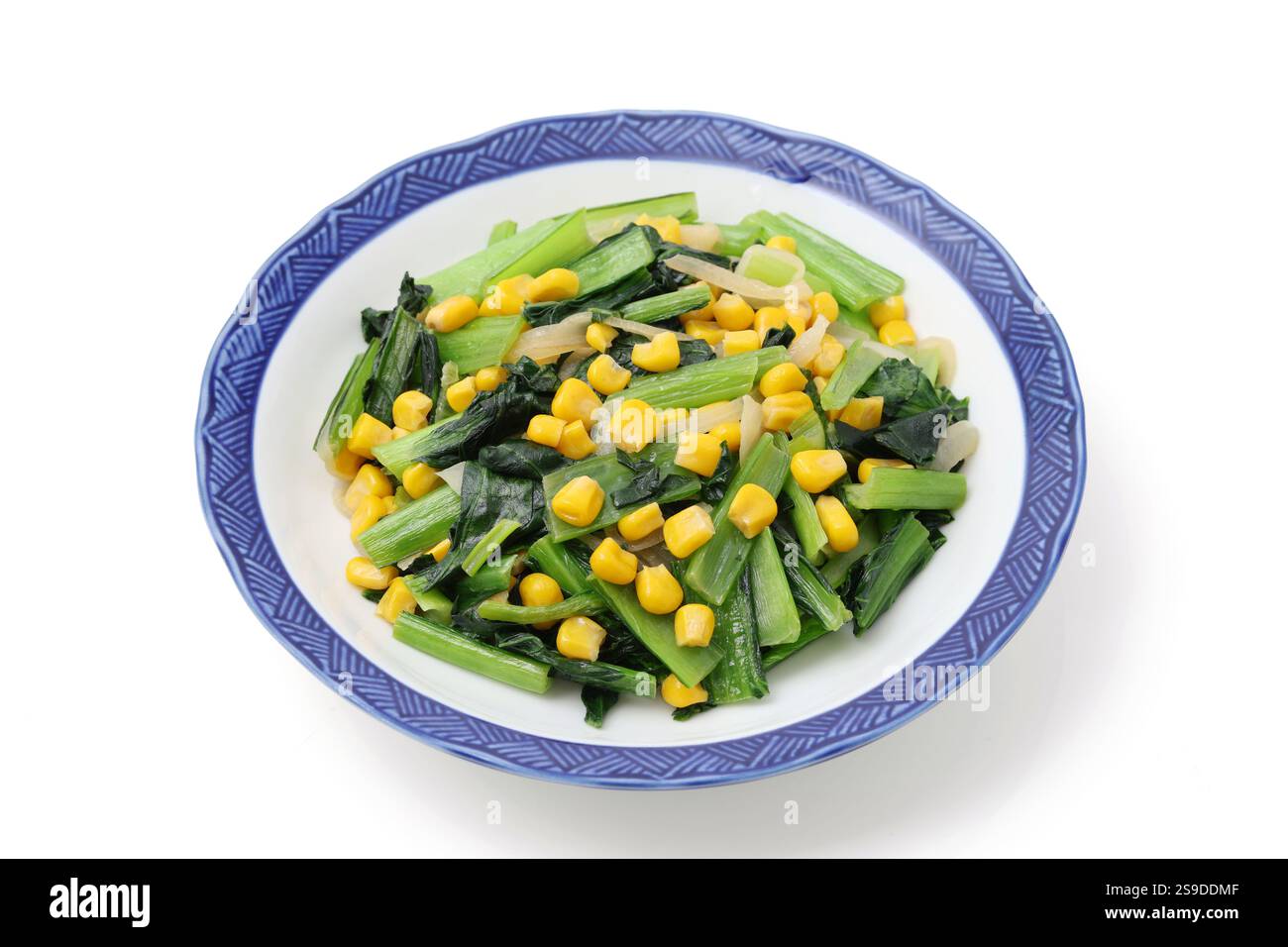 Corn and Japanese Komatsuna leaves vegetable stir-fry in a plate on ...