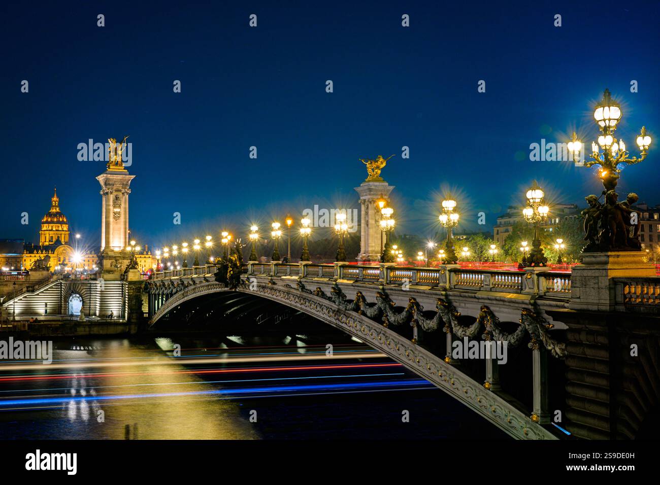 A photograph of the Alexandre III Bridge illuminated with light ...