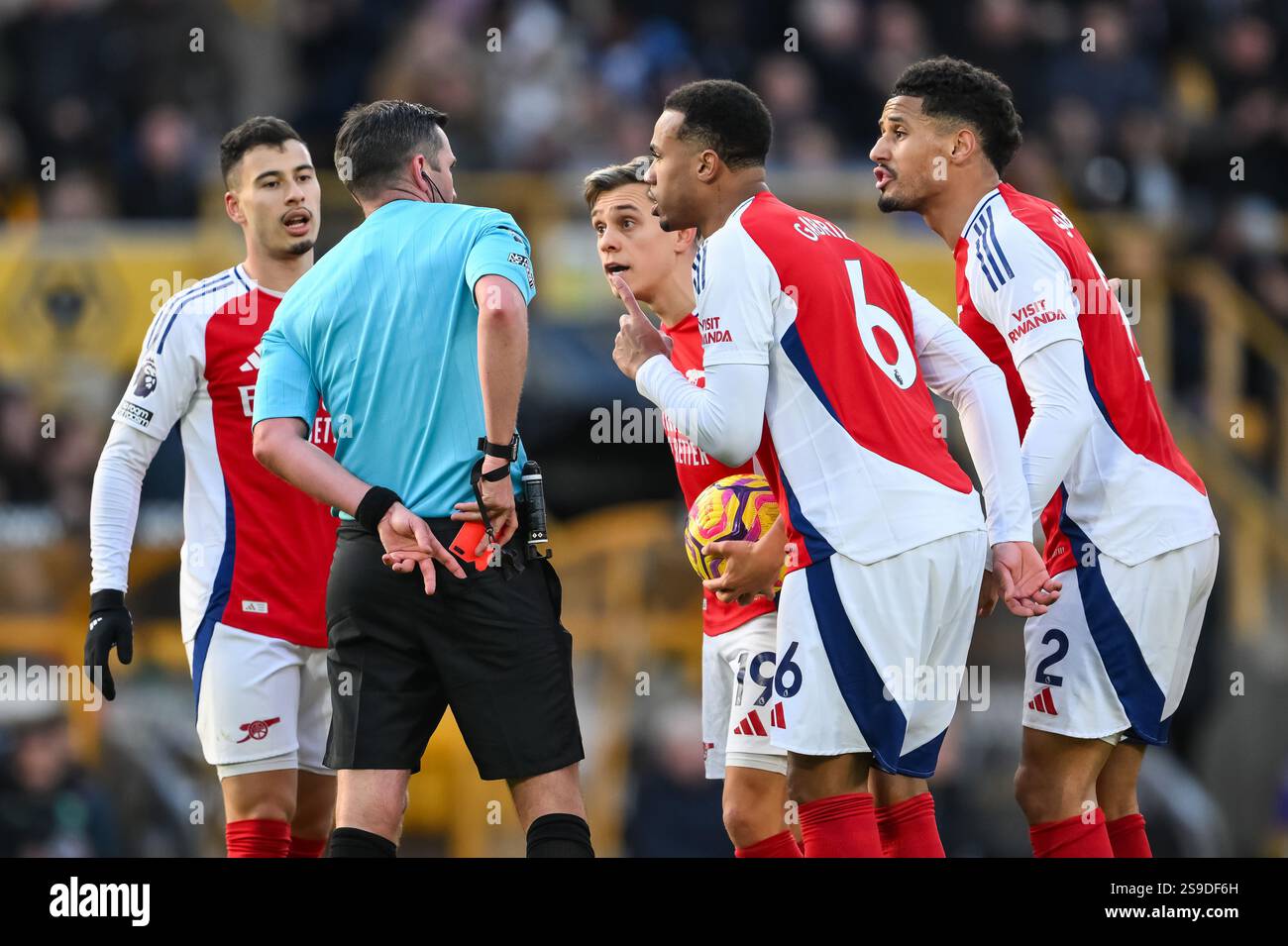 Arsenal players surround Referee Michael Oliver after he gives the red ...