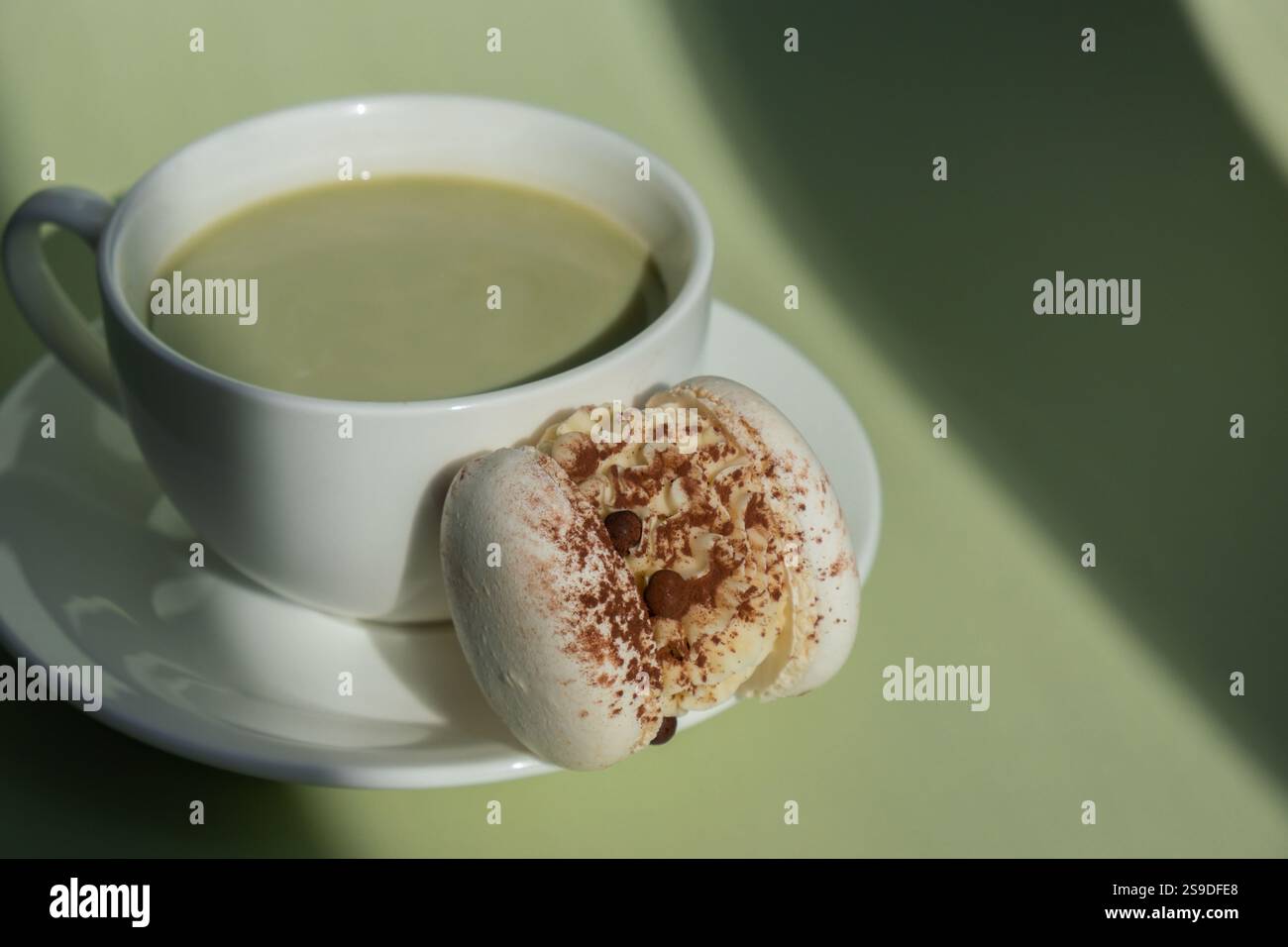 Nutrient-rich matcha drink with macaron dessert and trendy deep shadows ...