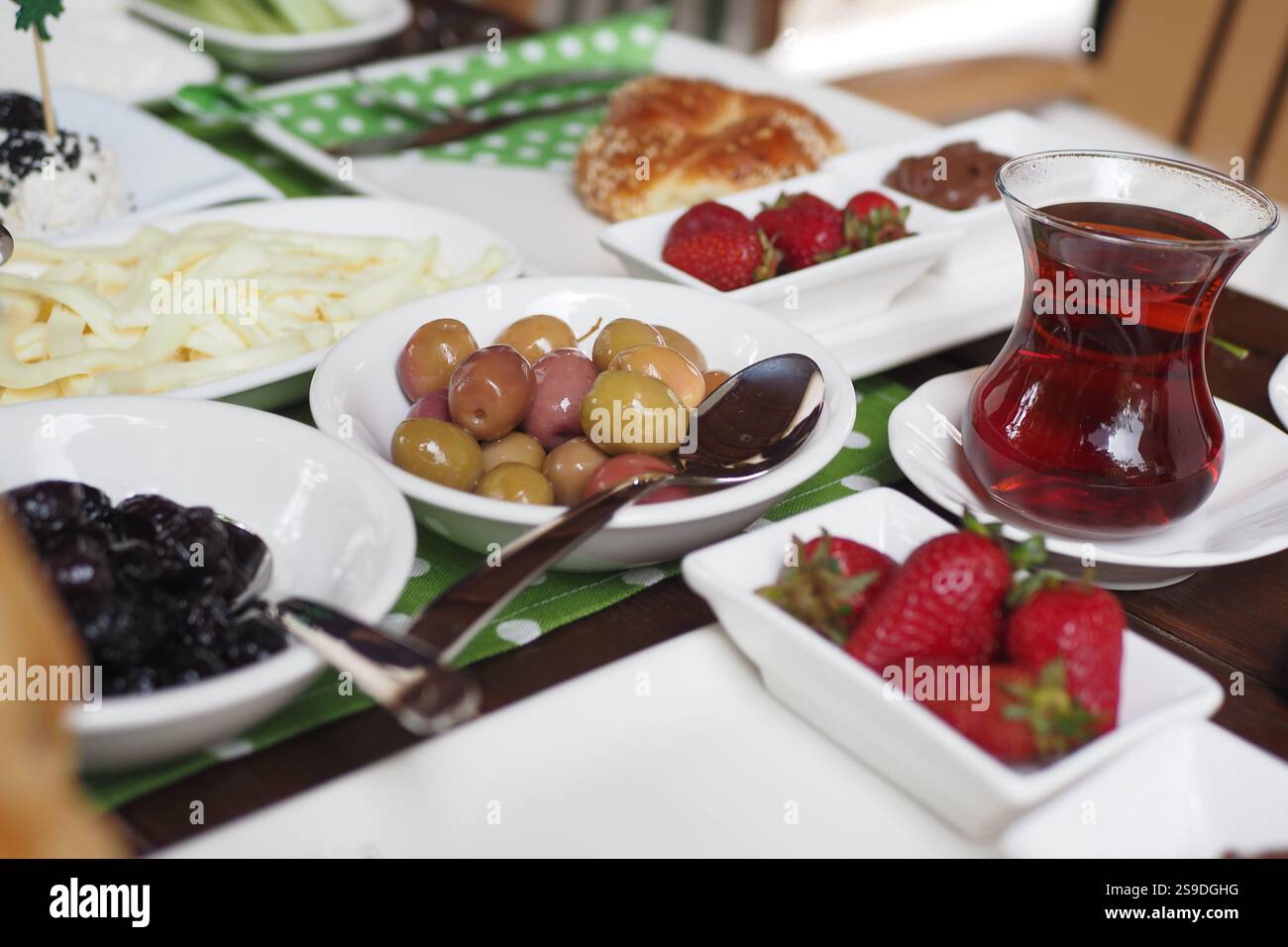 Traditional Breakfast Table Featuring Tea, Fresh Fruits, Olives, and ...