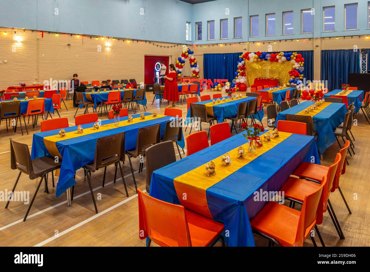 A sports hall set up with table, chairs and decorations ready for a ...