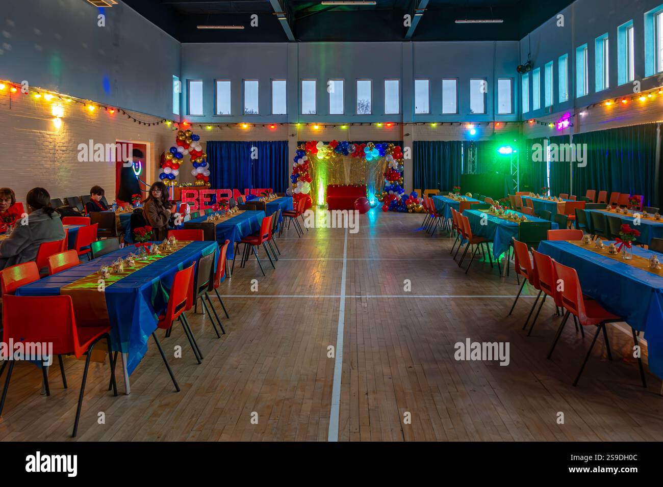 A sports hall set up with table, chairs and decorations ready for a ...