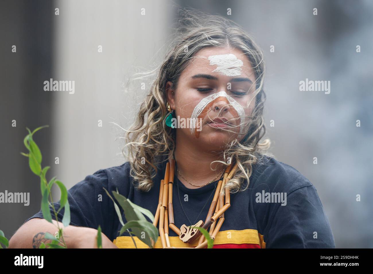 A young indigenous woman dances outside Parliament of Victoria during ...