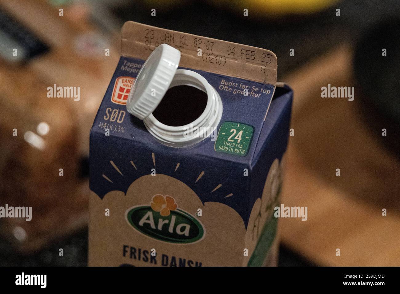 This photograph shows a milk carton of Arla and its tethered cap in ...