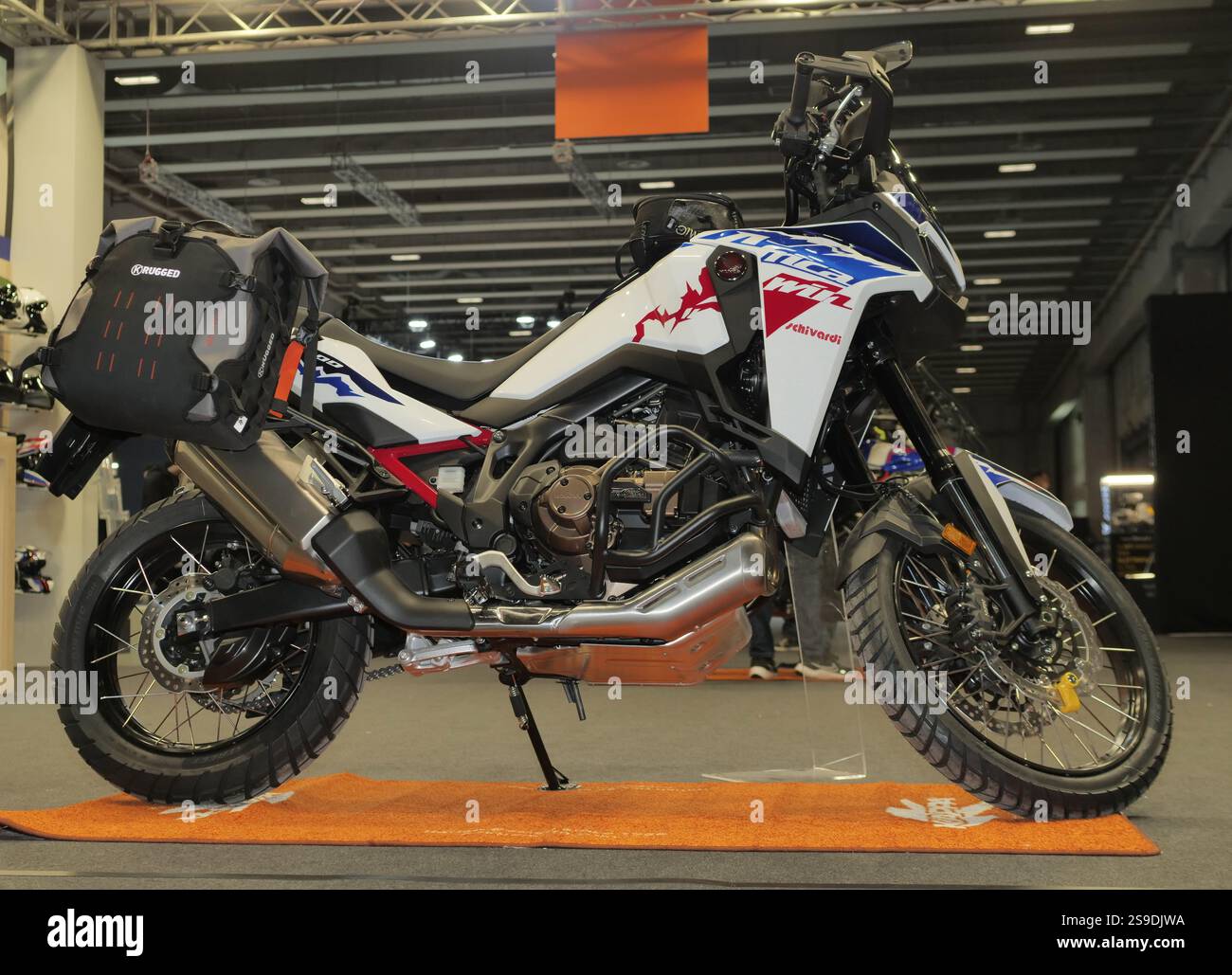 Motorcycles, helmets, accessories on display and models riding ...