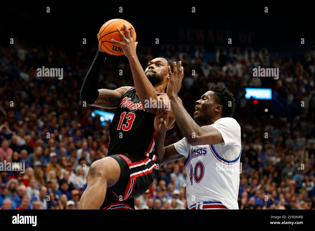Houston forward J'Wan Roberts (13) slips past Kansas forward Flory ...