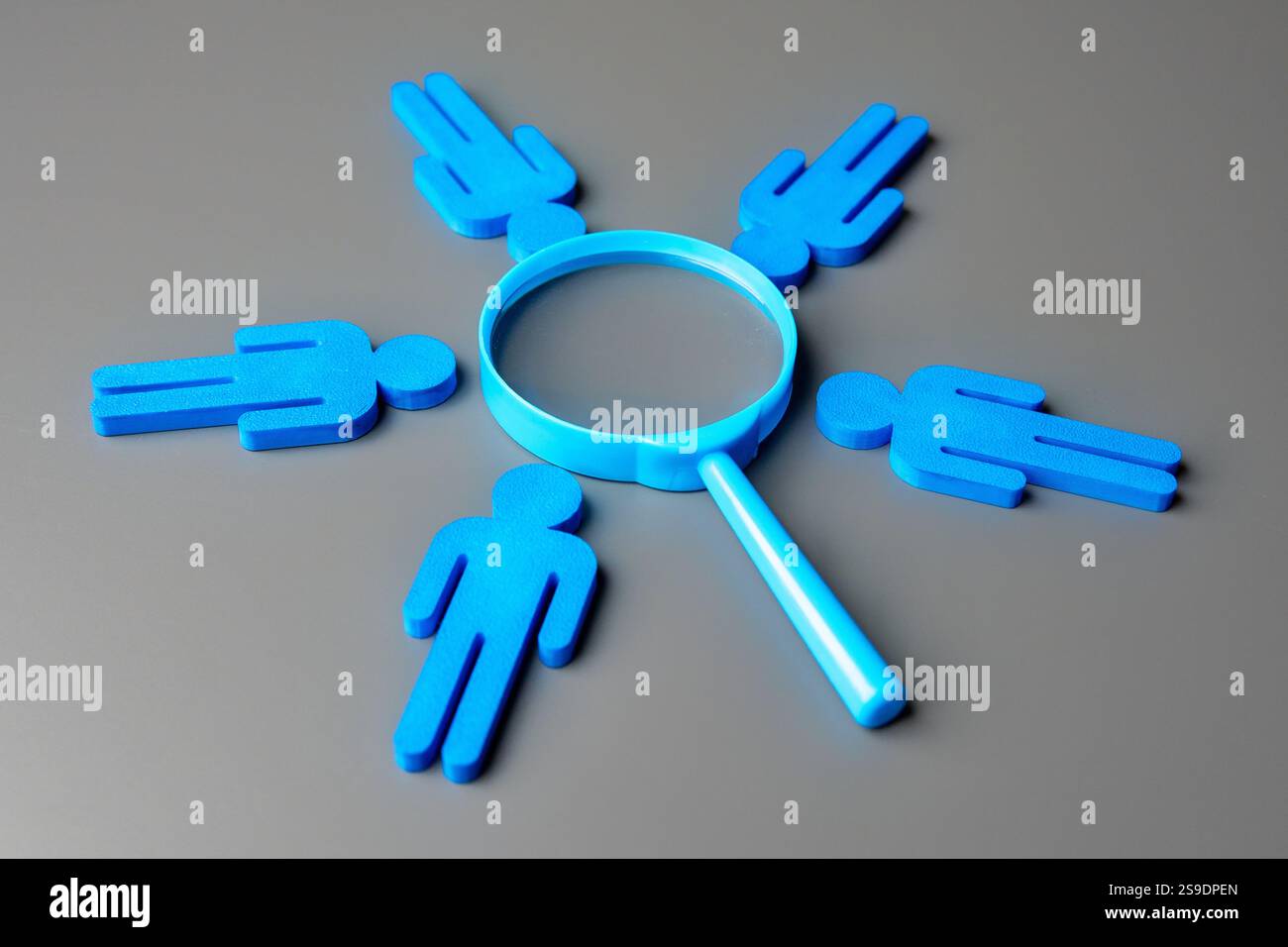 A magnifying glass and a group of blue figures. Recruitment and talent ...