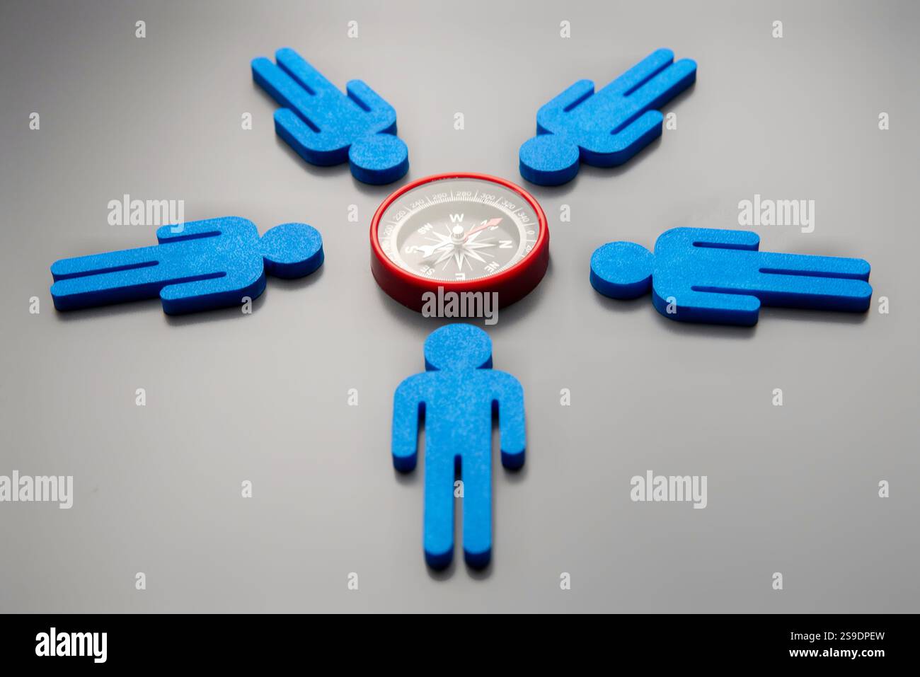 A compass surrounded by blue figures, symbolizing leadership, guidance ...