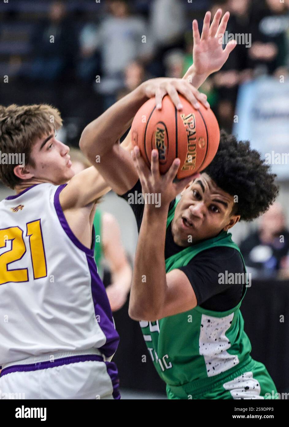 Owensboro Catholic's Dre'Mail Carothers, right, drives to the basket ...