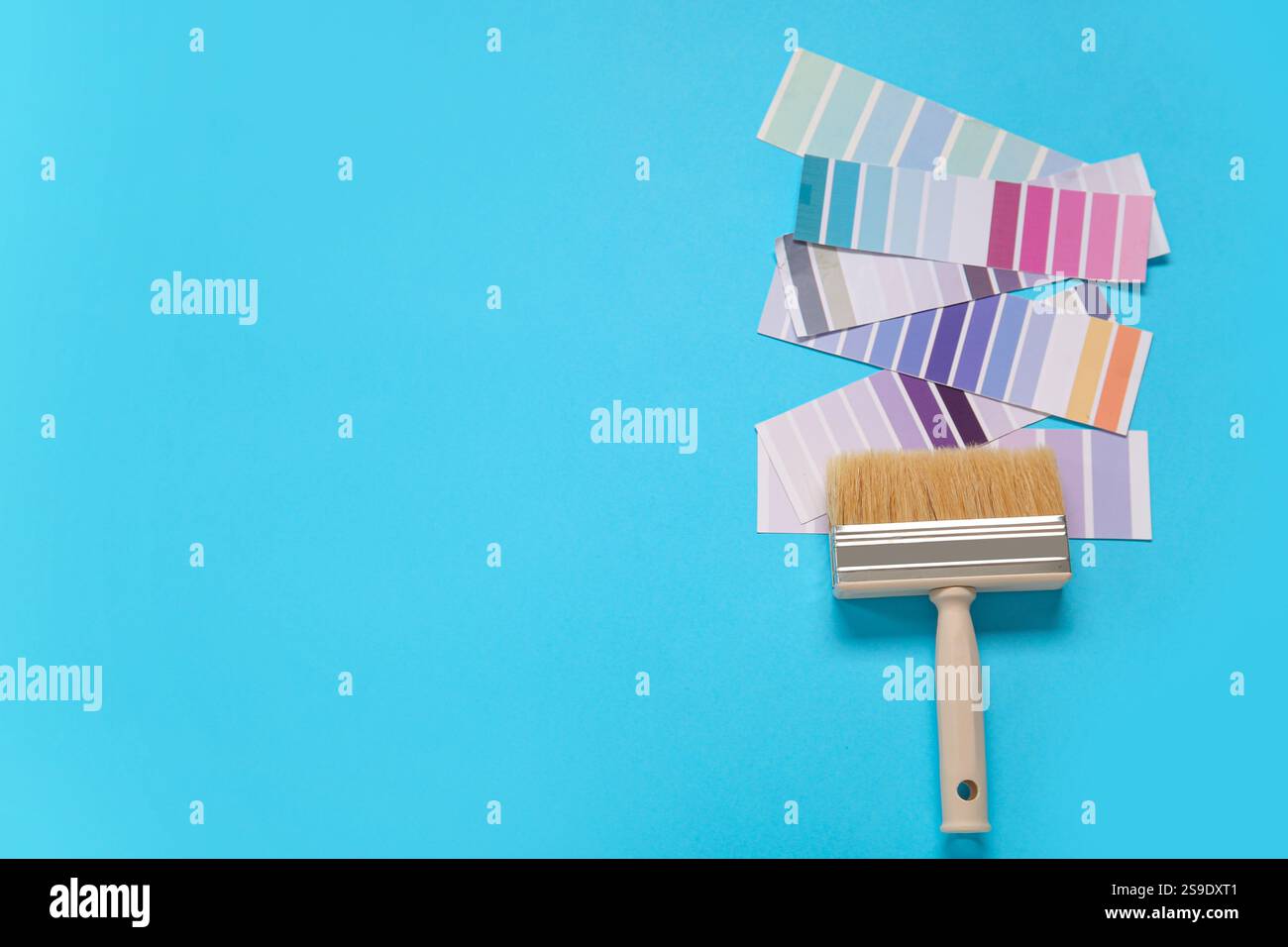 Many color palettes and brush on blue background Stock Photo - Alamy