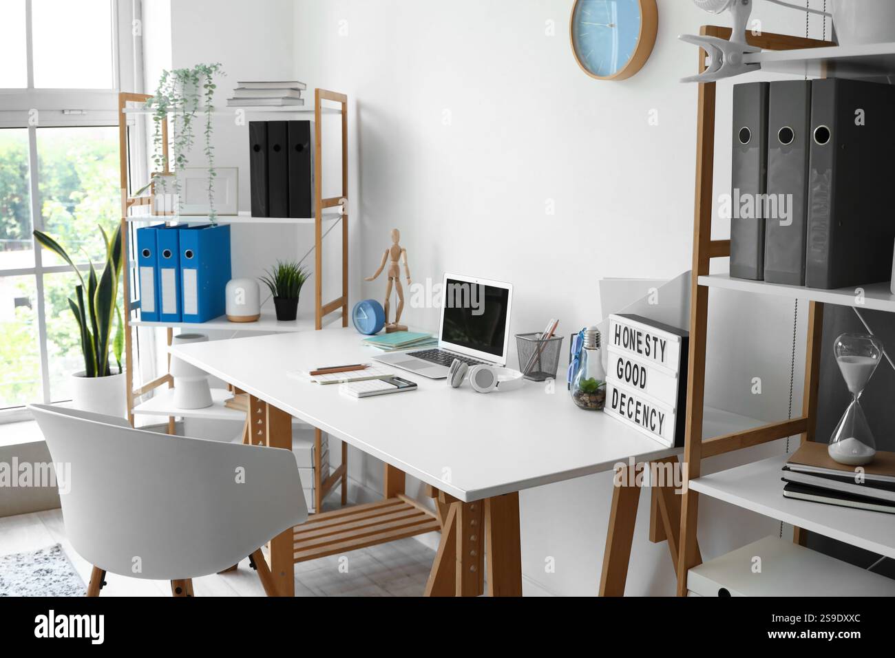 Interior of light office with modern workplace and shelving units Stock ...