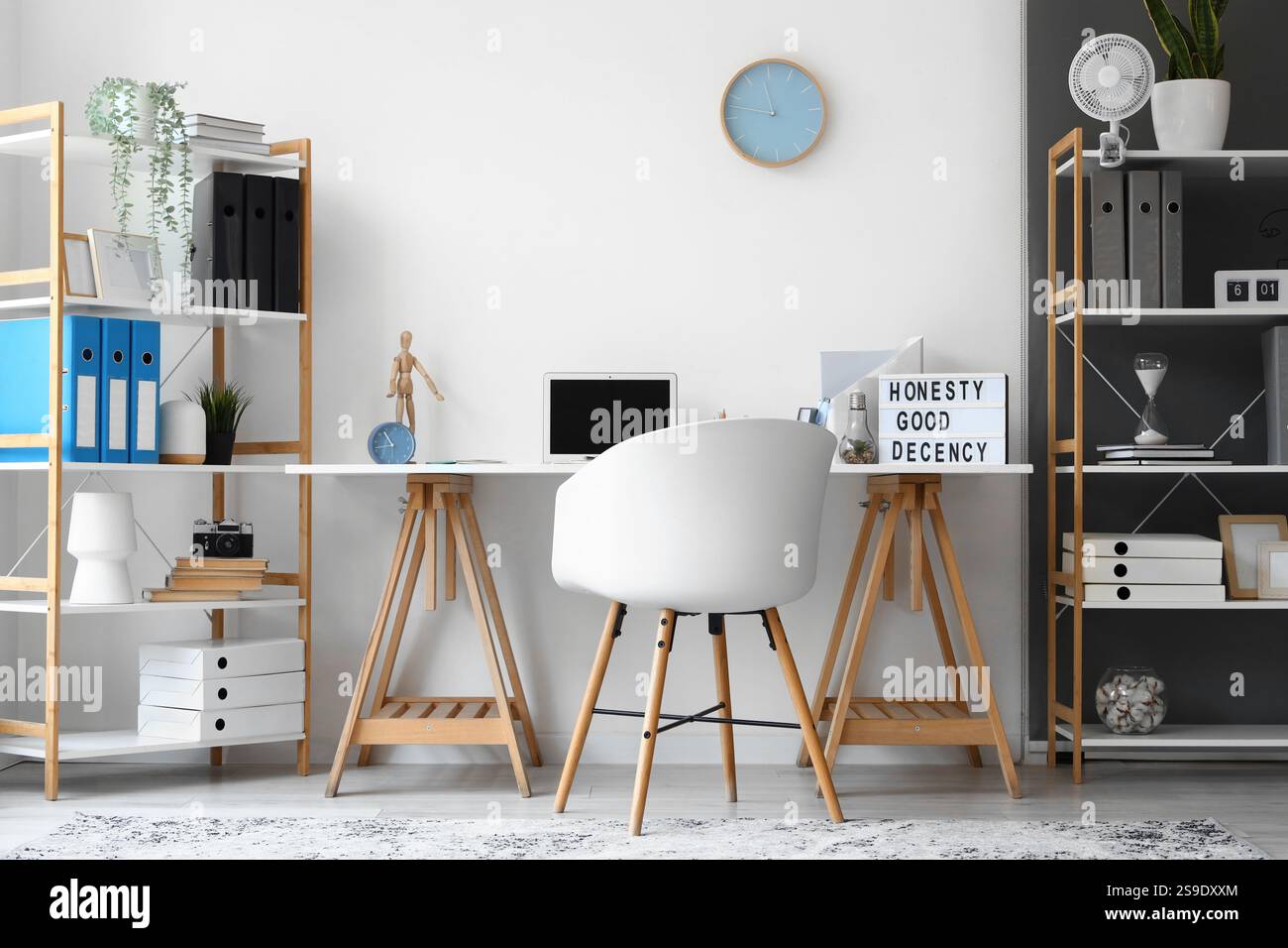 Interior of light office with modern workplace and shelving units Stock ...