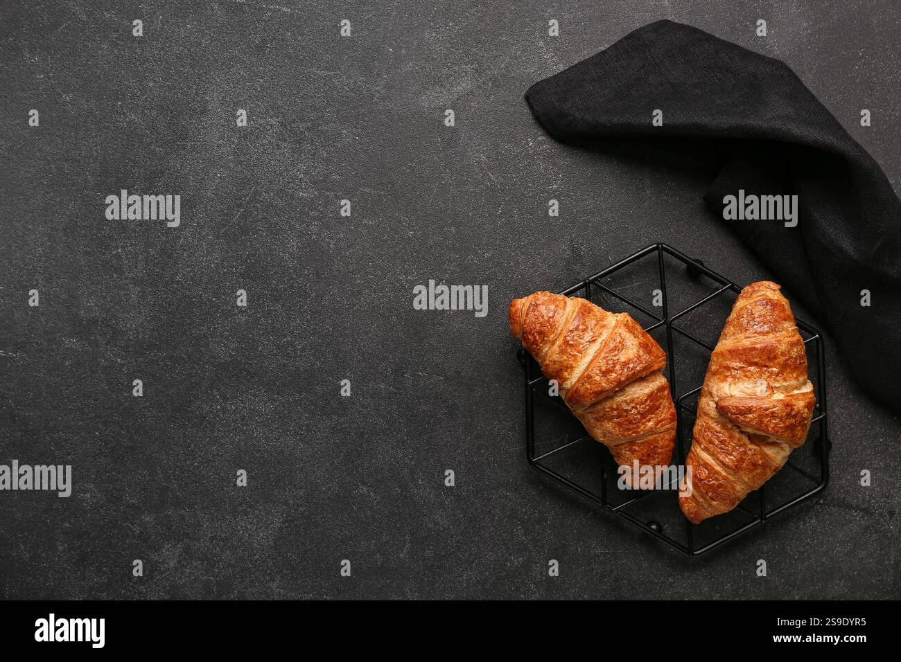 Stand with tasty croissants on black background Stock Photo - Alamy