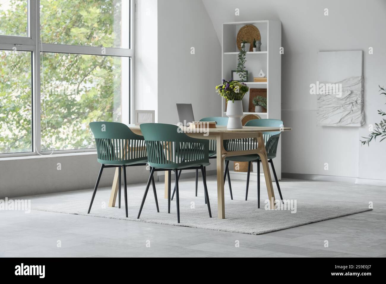 Interior of dining room with table and shelf unit Stock Photo - Alamy