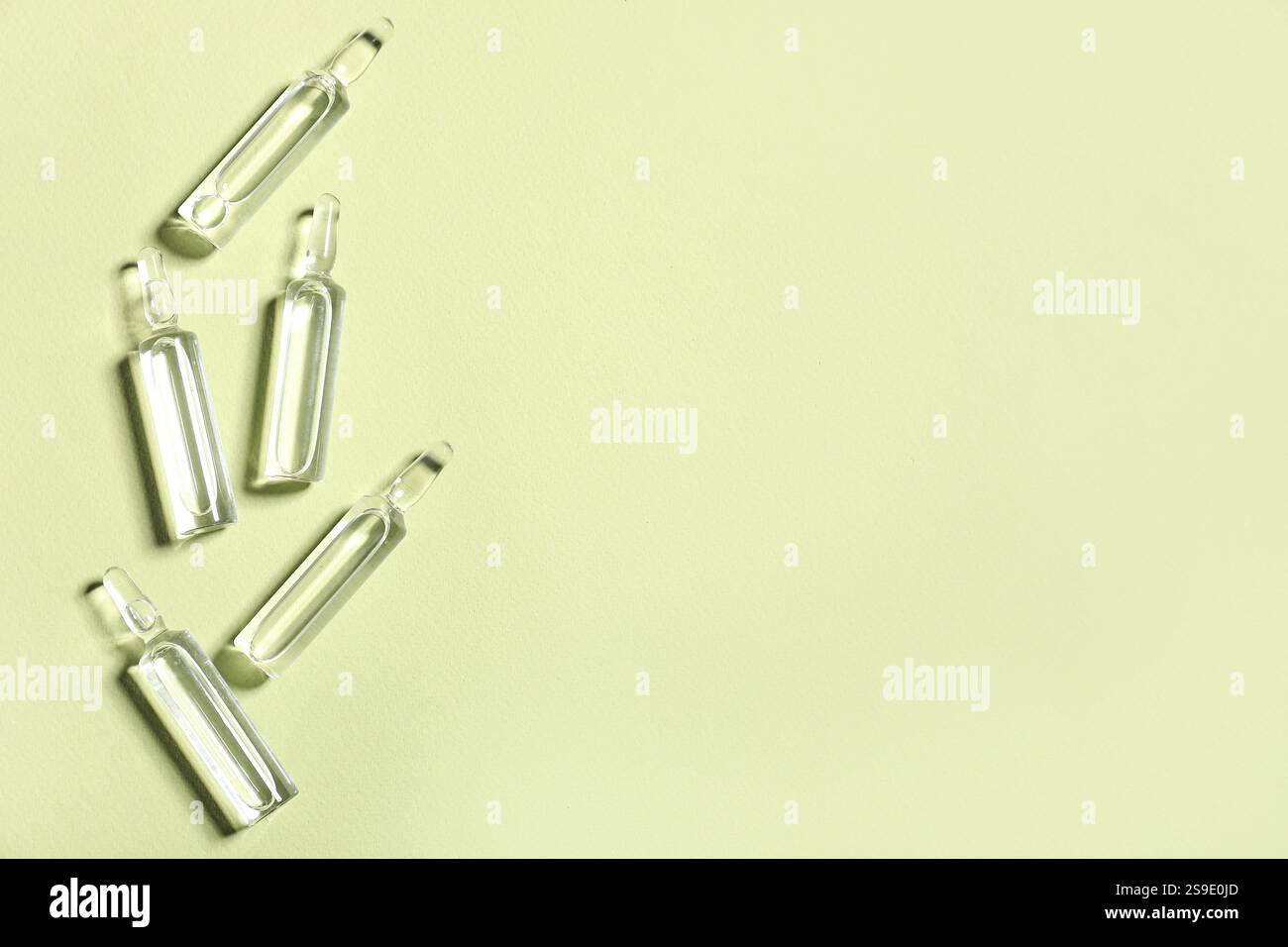 Medical ampules on green background Stock Photo - Alamy