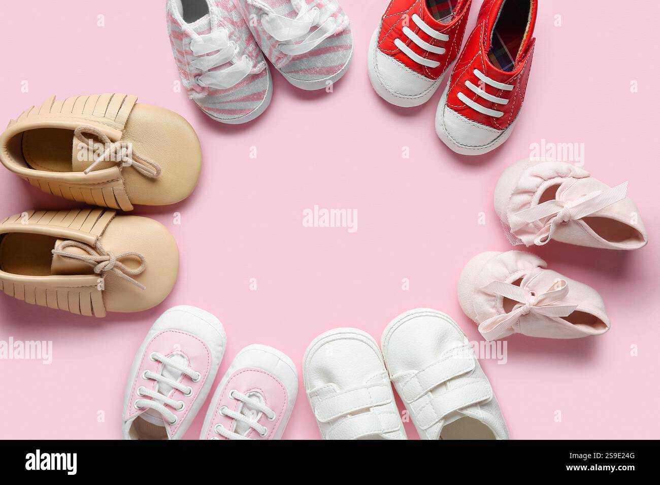 Frame made of different cute baby booties on pink background Stock ...
