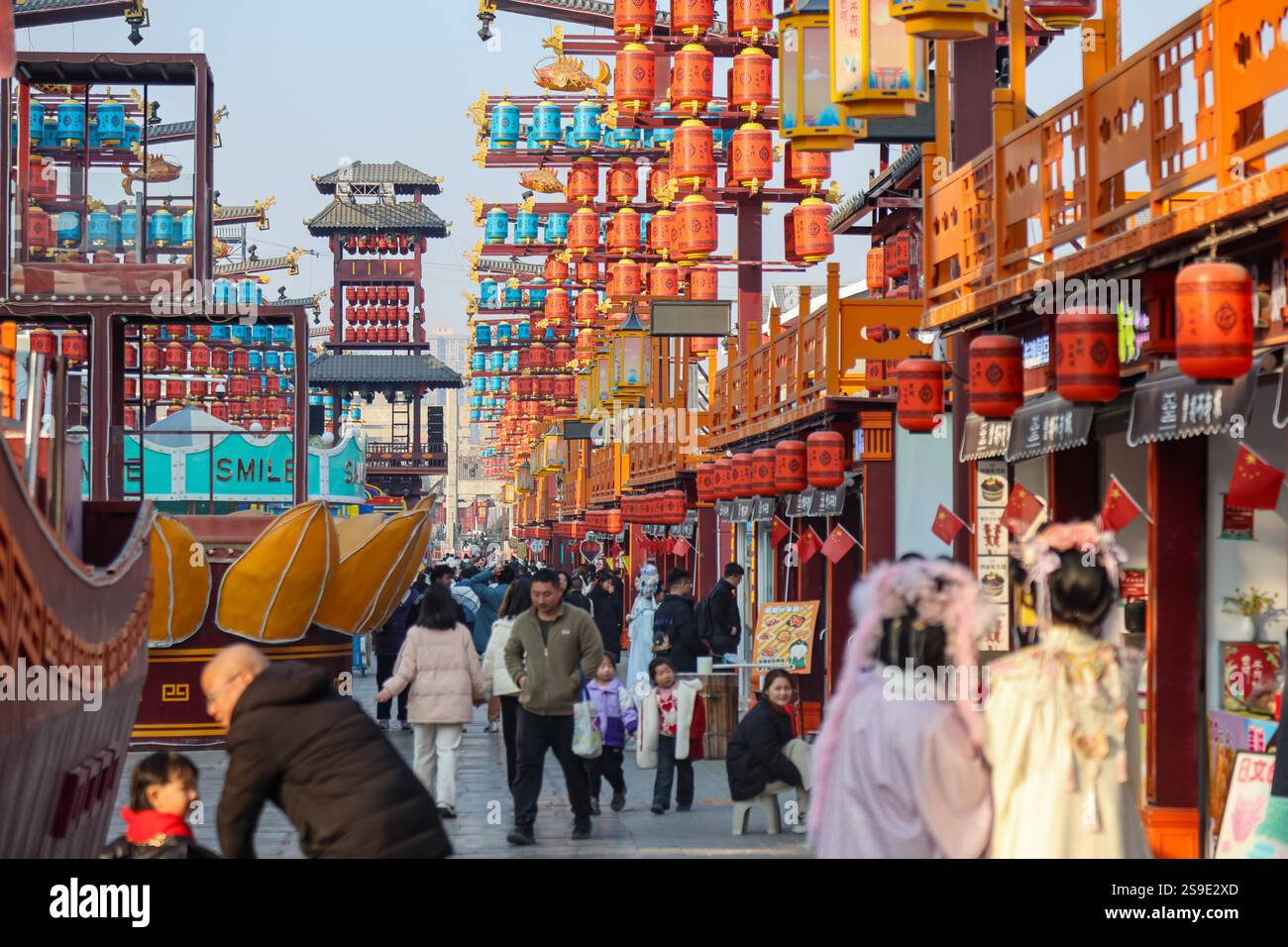 Tourists stroll at a walking street in Xuchang City, central China's ...
