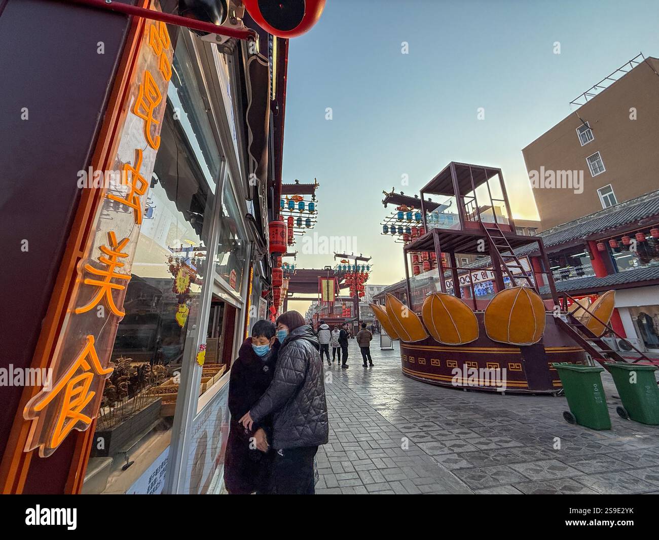 Tourists stroll at a walking street in Xuchang City, central China's ...