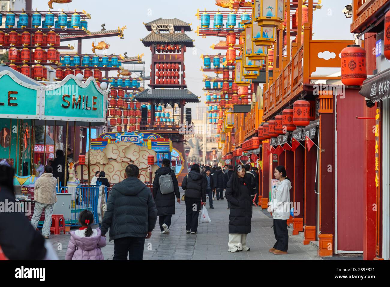 Tourists stroll at a walking street in Xuchang City, central China's ...