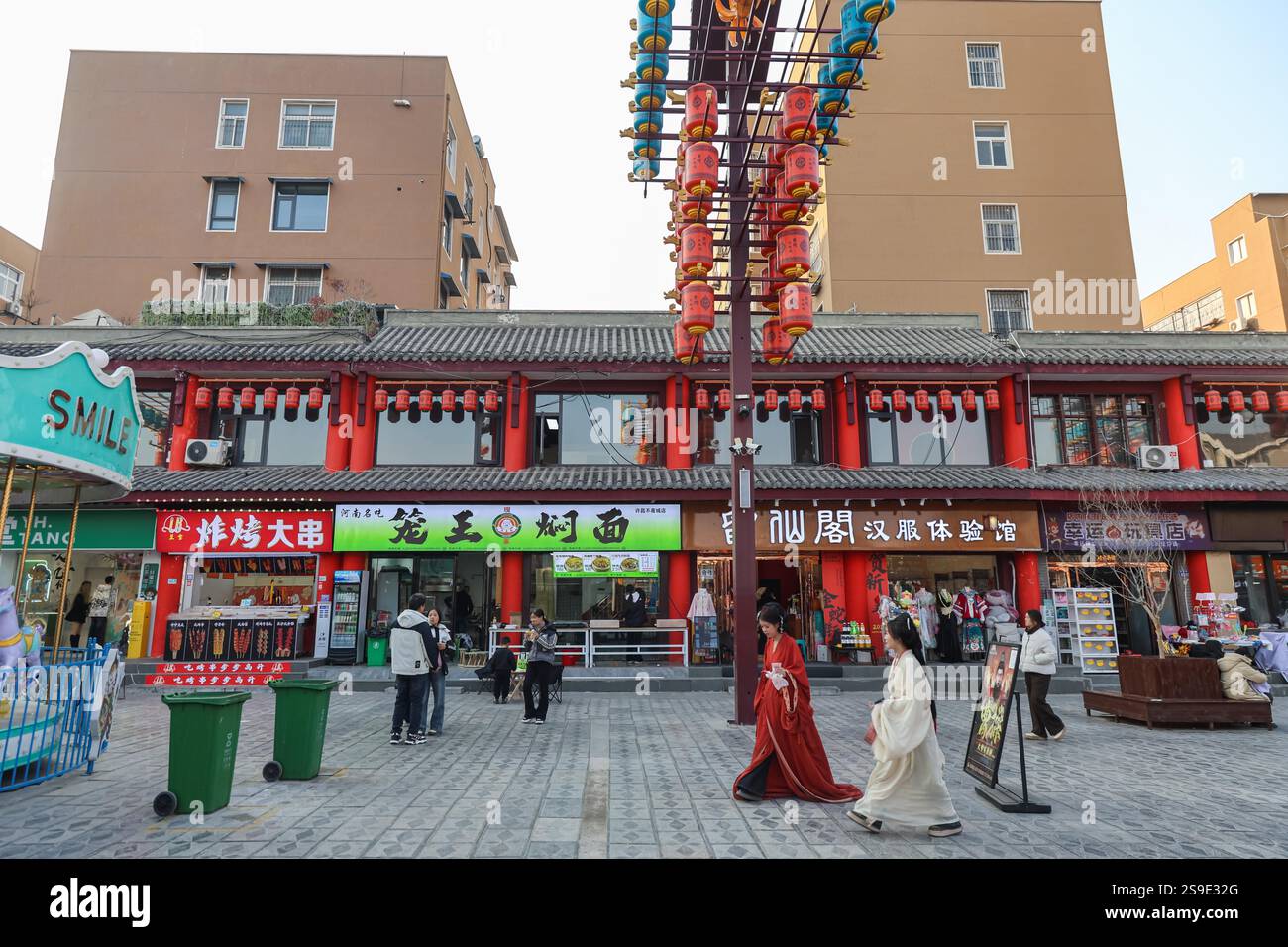 Tourists stroll at a walking street in Xuchang City, central China's ...