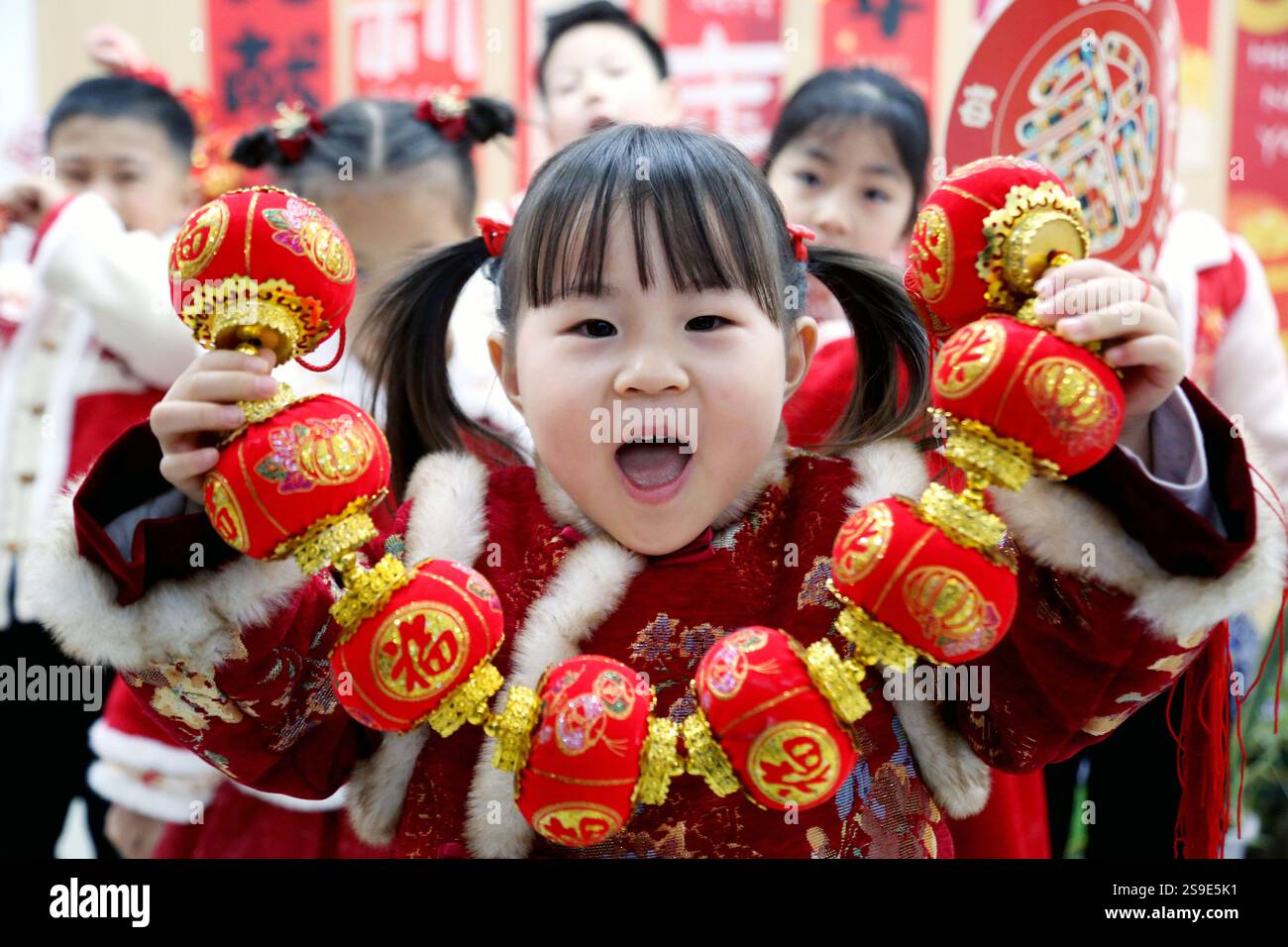 A child holds ornaments to welcome Chinese Lunar New Year at a ...