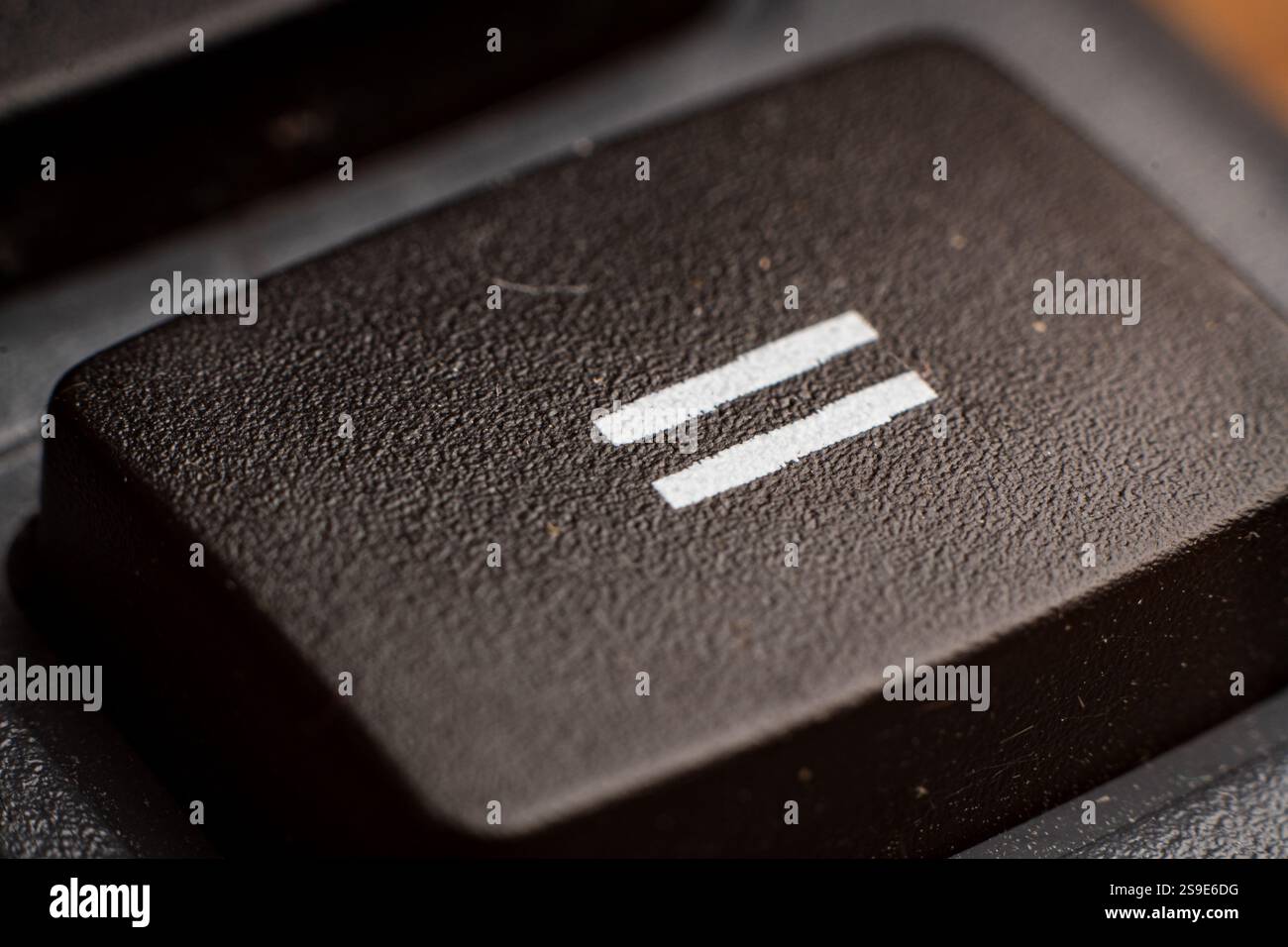 Closeup view of electronic keypad highlighting the equal sum button ...