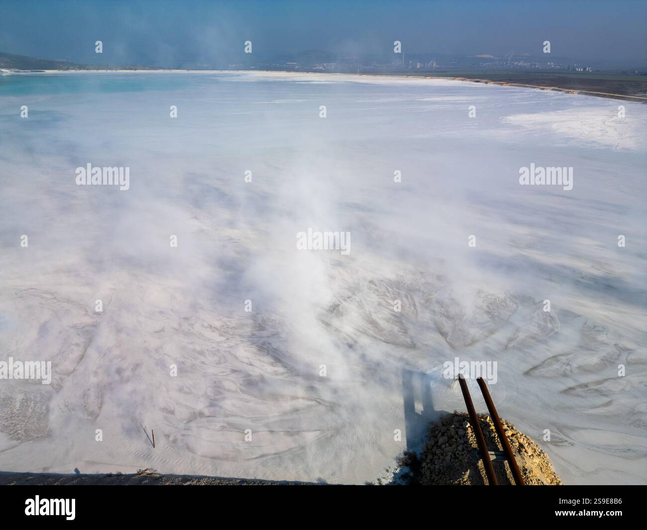 A tailings lake of a cement factory with pipes visibly discharging ...