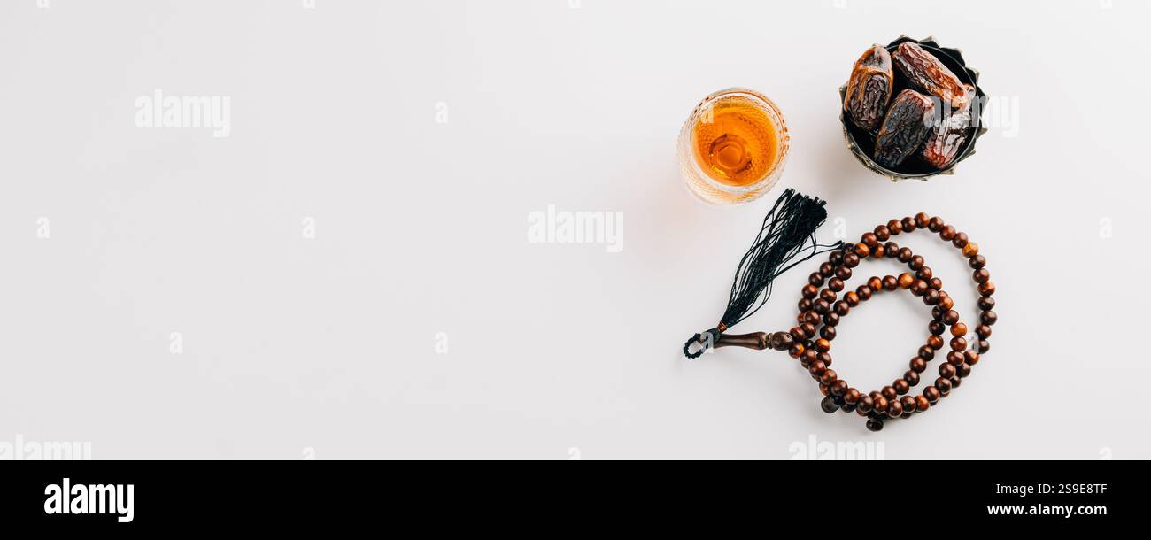 Ramadan flat lay, dates fruit, rosary beads, and tea on a clean white ...