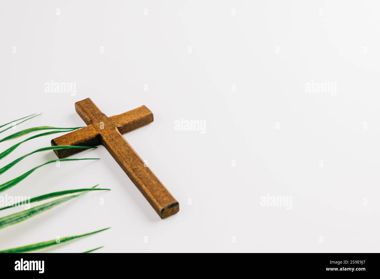 Palm Sunday concept with wooden cross and green palm fronds on ...