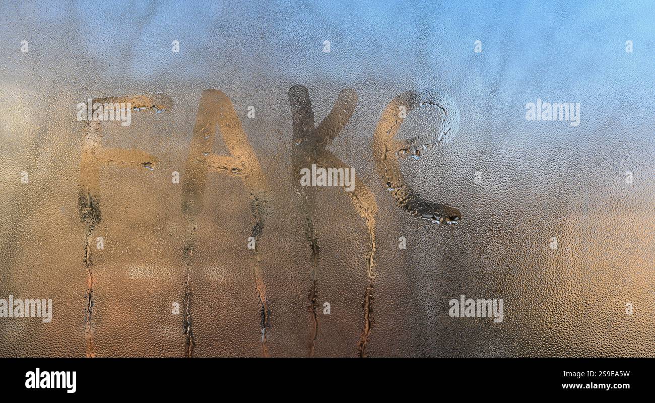 the word fake is written on the glass. concept Stock Photo - Alamy
