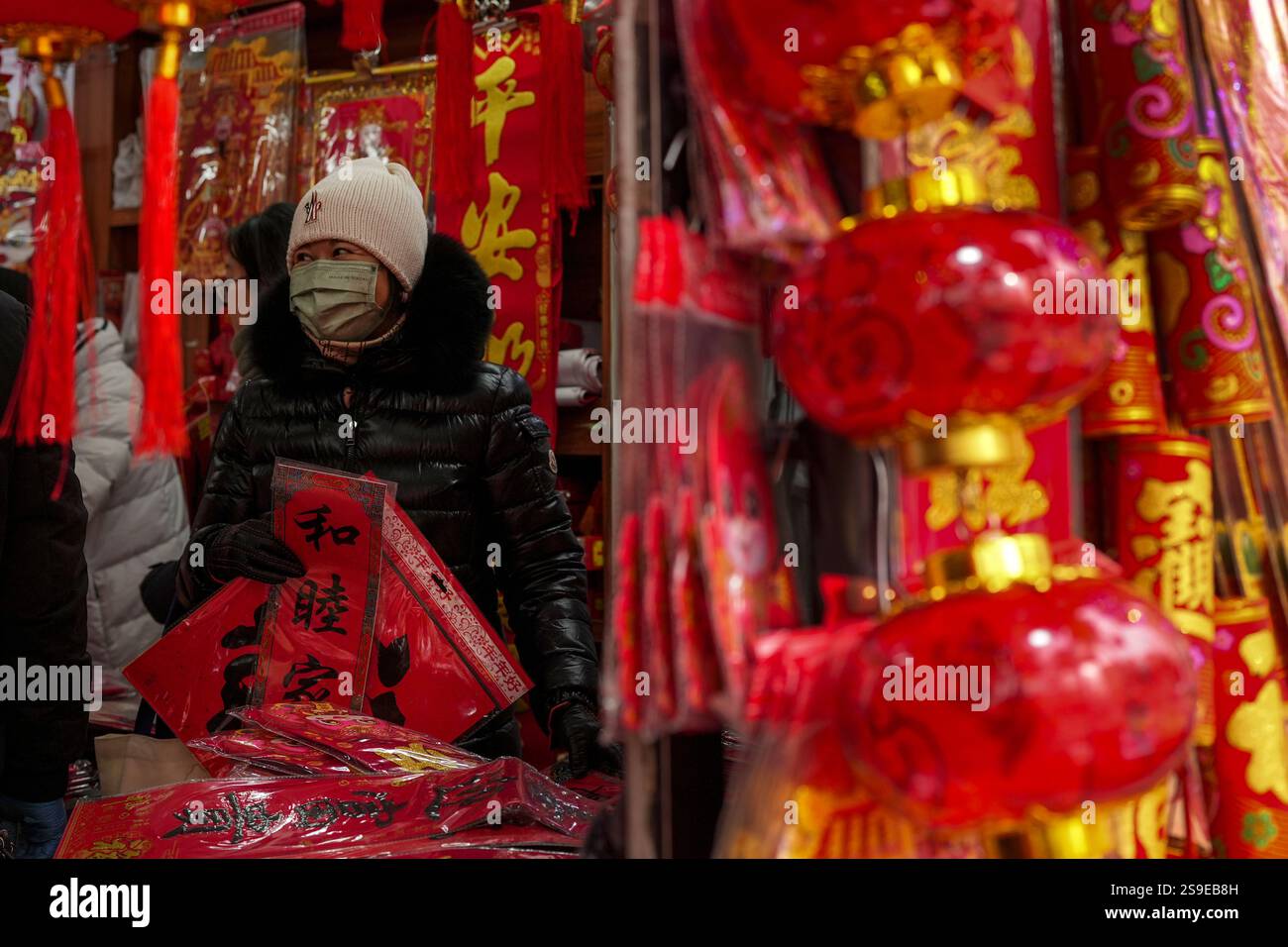 Women shop for prosperity decorations at a store ahead of the Chinese ...