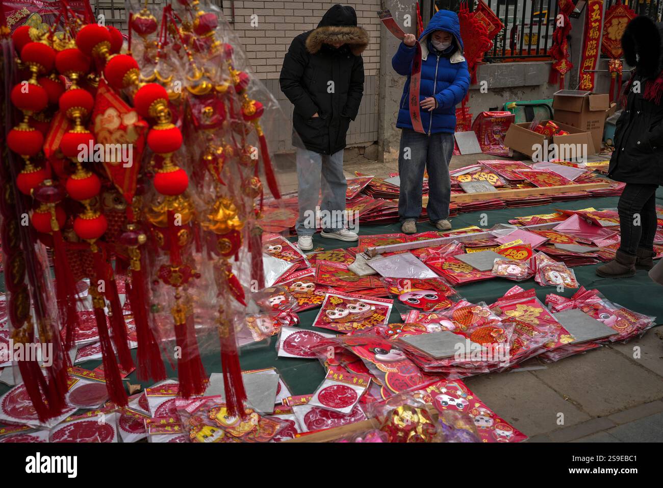 Residents shop for prosperity decorations at a pavement store ahead of ...