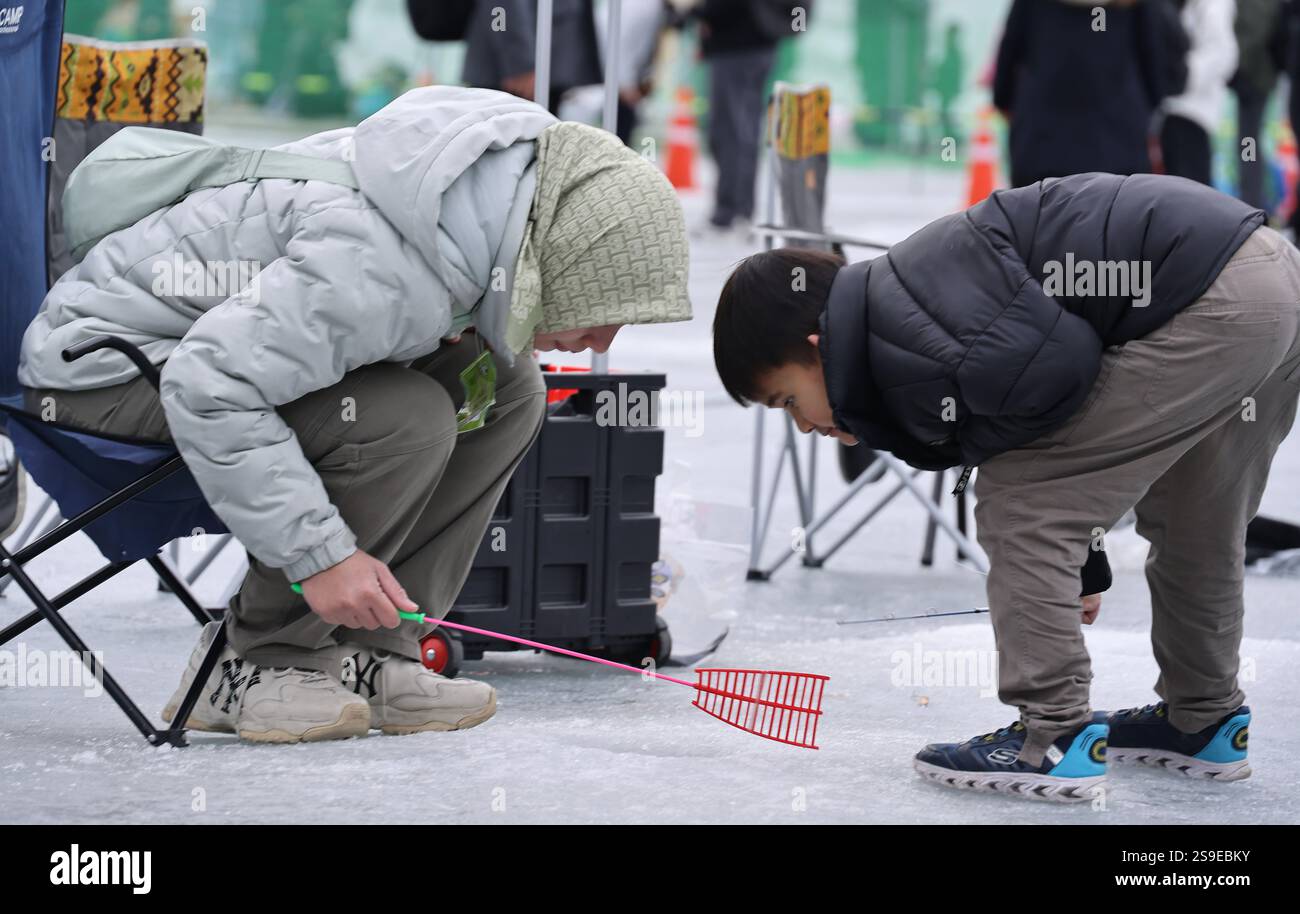 Hwacheon Sancheoneo Ice Festival in Hwacheon-gun A family ice fishing ...