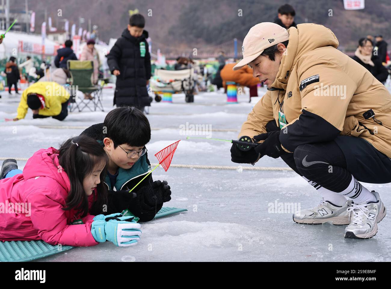 Hwacheon Sancheoneo Ice Festival in Hwacheon-gun A family ice fishing ...