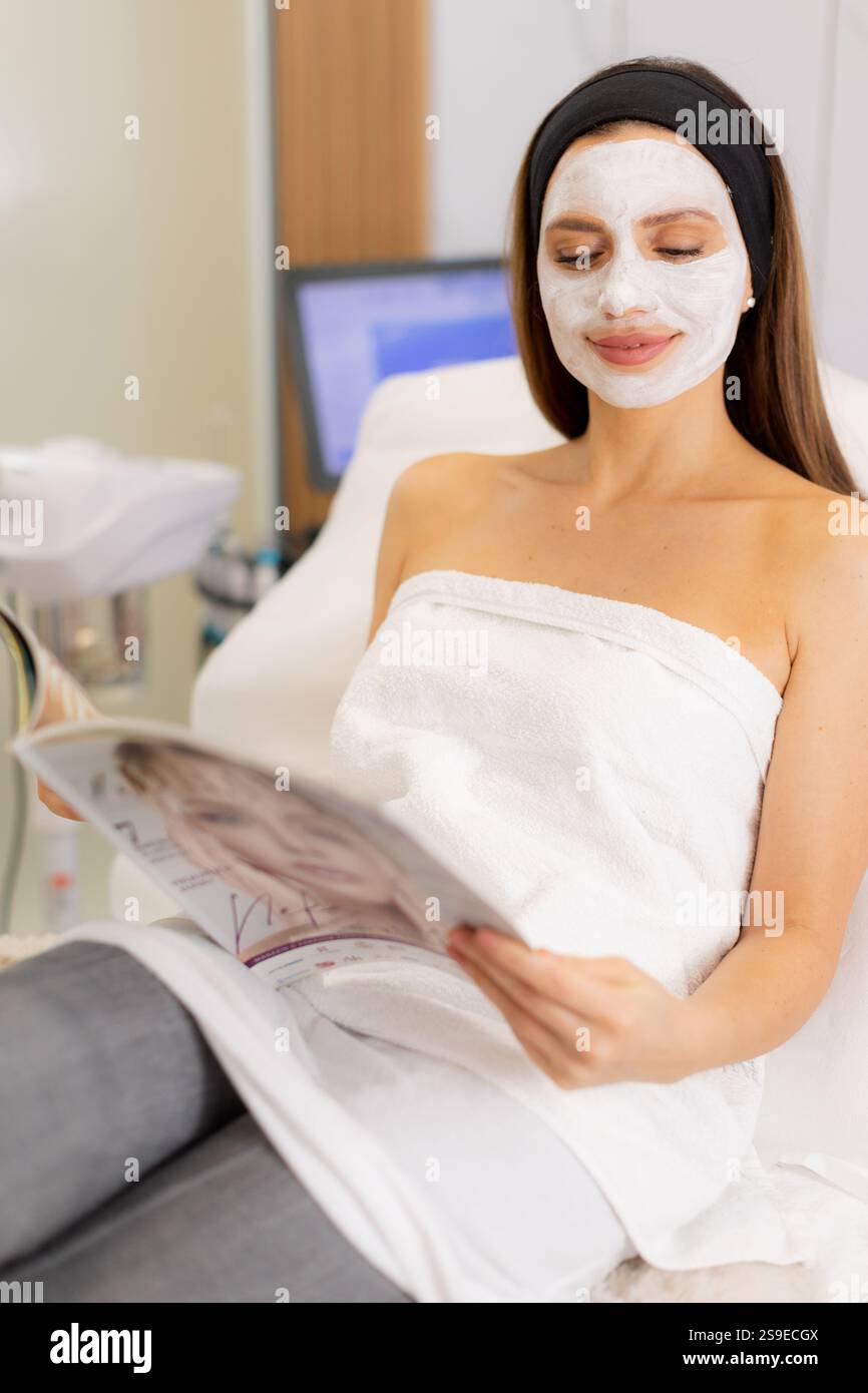 A serene moment in a wellness center where a woman with a facial mask ...