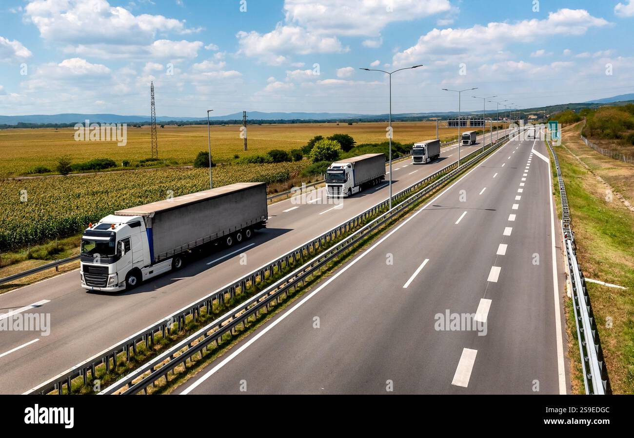 Convoy of white Trucks with containers on highway, cargo transportation ...
