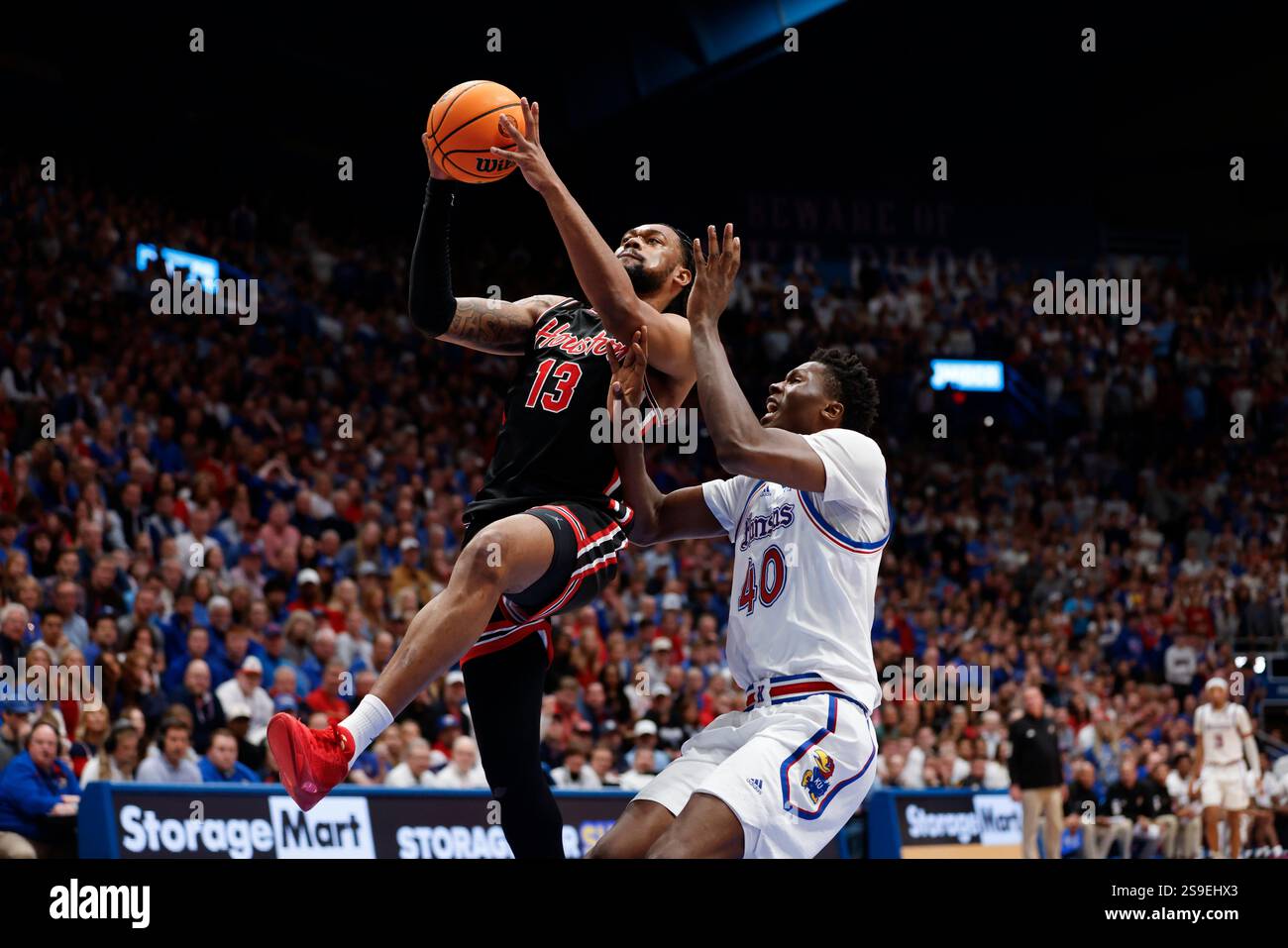 Houston forward J'Wan Roberts (13) slips past Kansas forward Flory ...