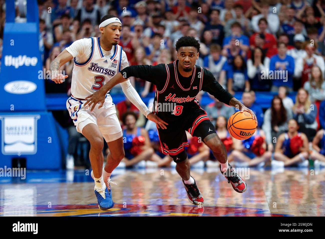 Houston guard Mylik Wilson (8) drives down the court as Kansas guard ...