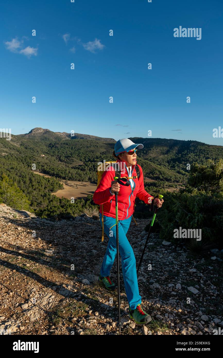 Photo of a woman carrying a backpack and hiking in the nature, Mariola ...