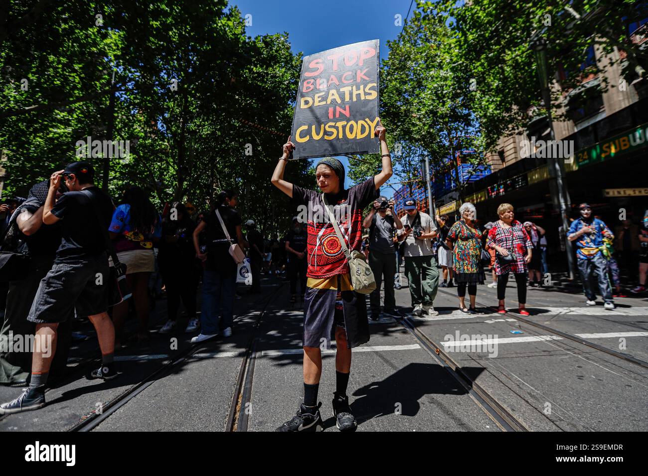 A protester holds a placard during the annual Invasion Day protest ...