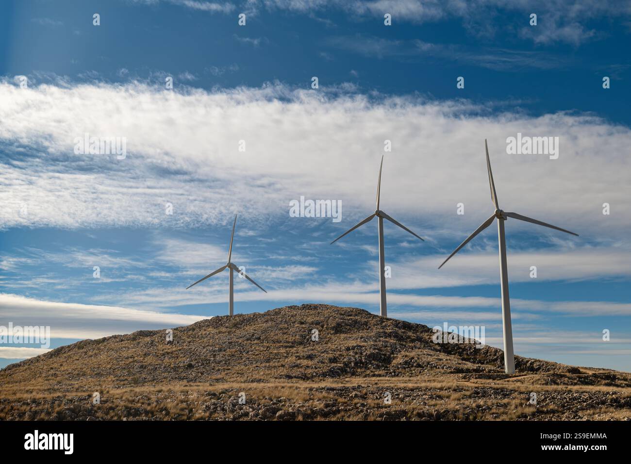 View of a natural landscape with hills and a windmill working in the ...