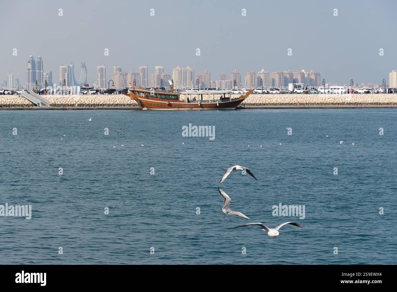 Doha, Qatar - January 4, 2025: A traditional dhow boat takes tourists ...