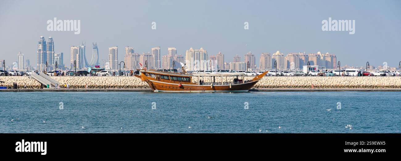 Doha, Qatar - January 4, 2025: A traditional dhow boat takes tourists ...