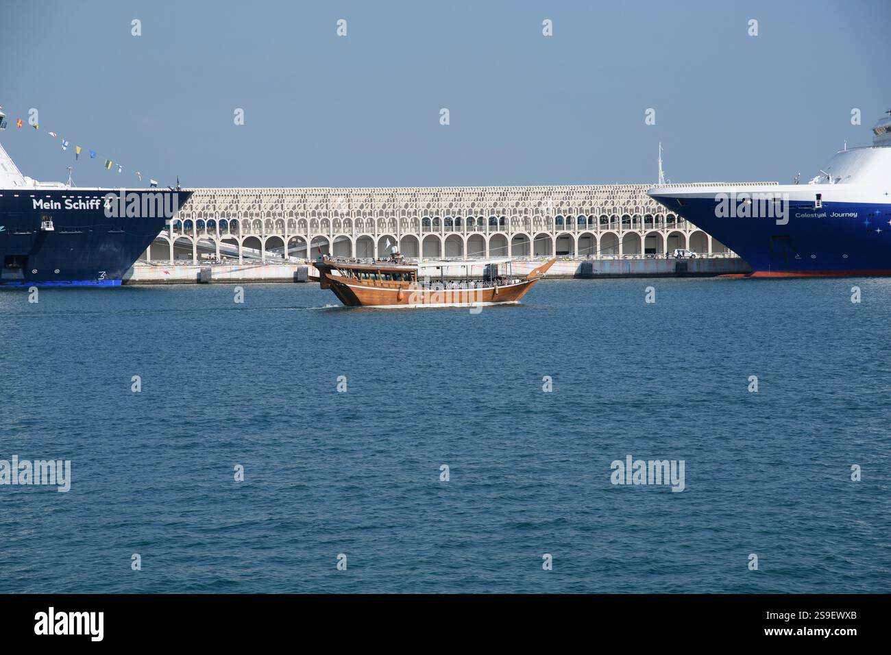 Doha, Qatar - January 4, 2025: A traditional dhow boat takes tourists ...