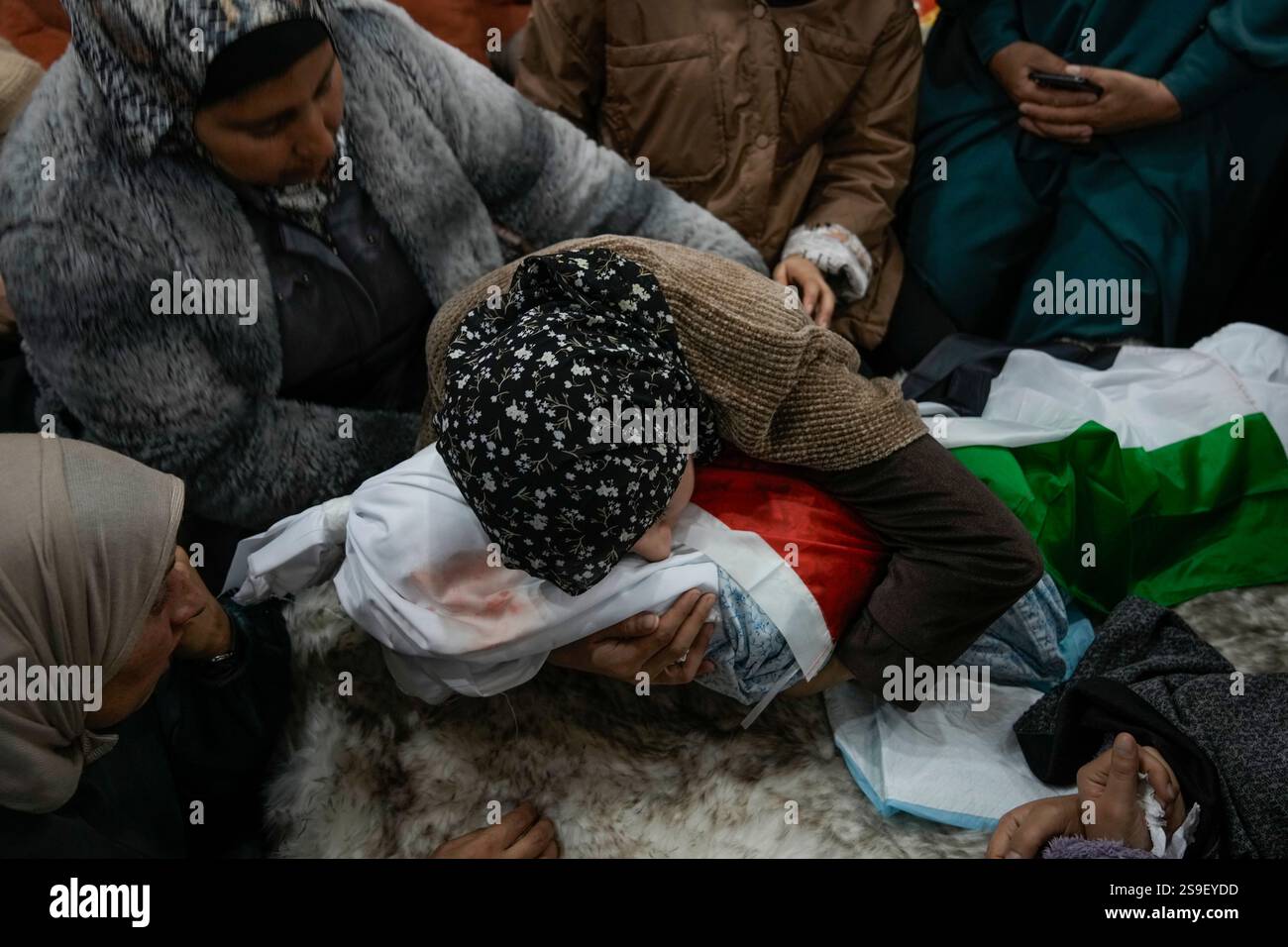 Tima Al-Khatib weeps over the body of her 2-year-old daughter Laila ...