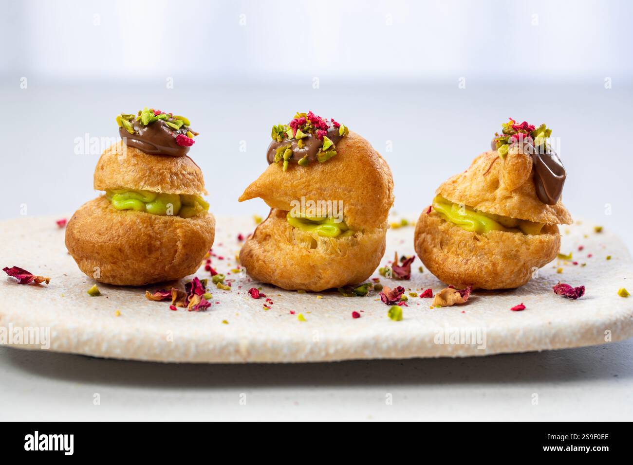 Elegant pistachio and raspberry profiterole Stock Photo - Alamy